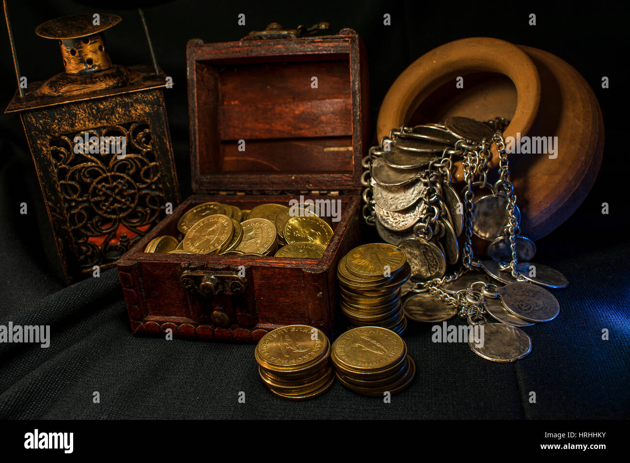 Treasure chest, pile and pillar of coins, a ceramic bowl filled with ...