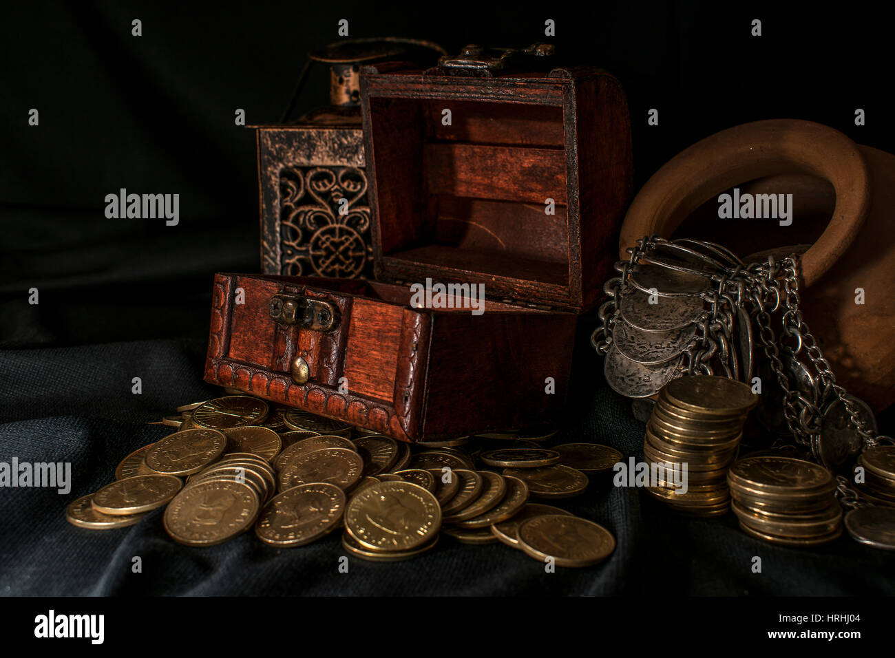 Treasure chest, pile and pillar of coins, a ceramic bowl filled with ...