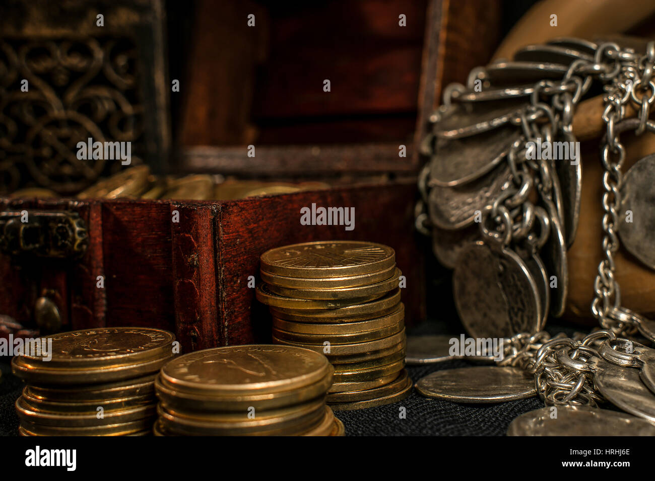 Treasure chest, pile and pillar of coins, a ceramic bowl filled with ...