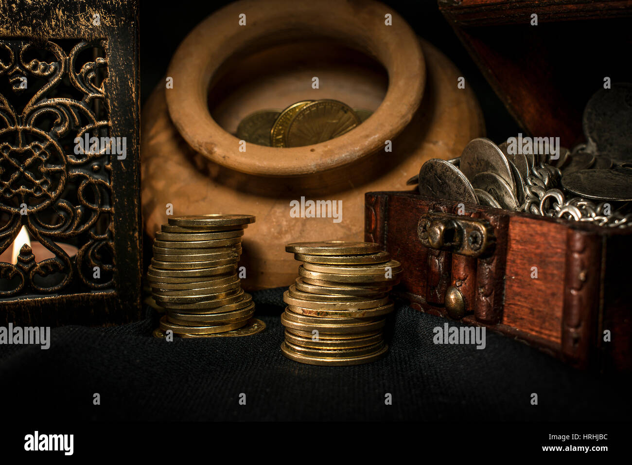 Treasure chest, pile and pillar of coins, a ceramic bowl filled with ...