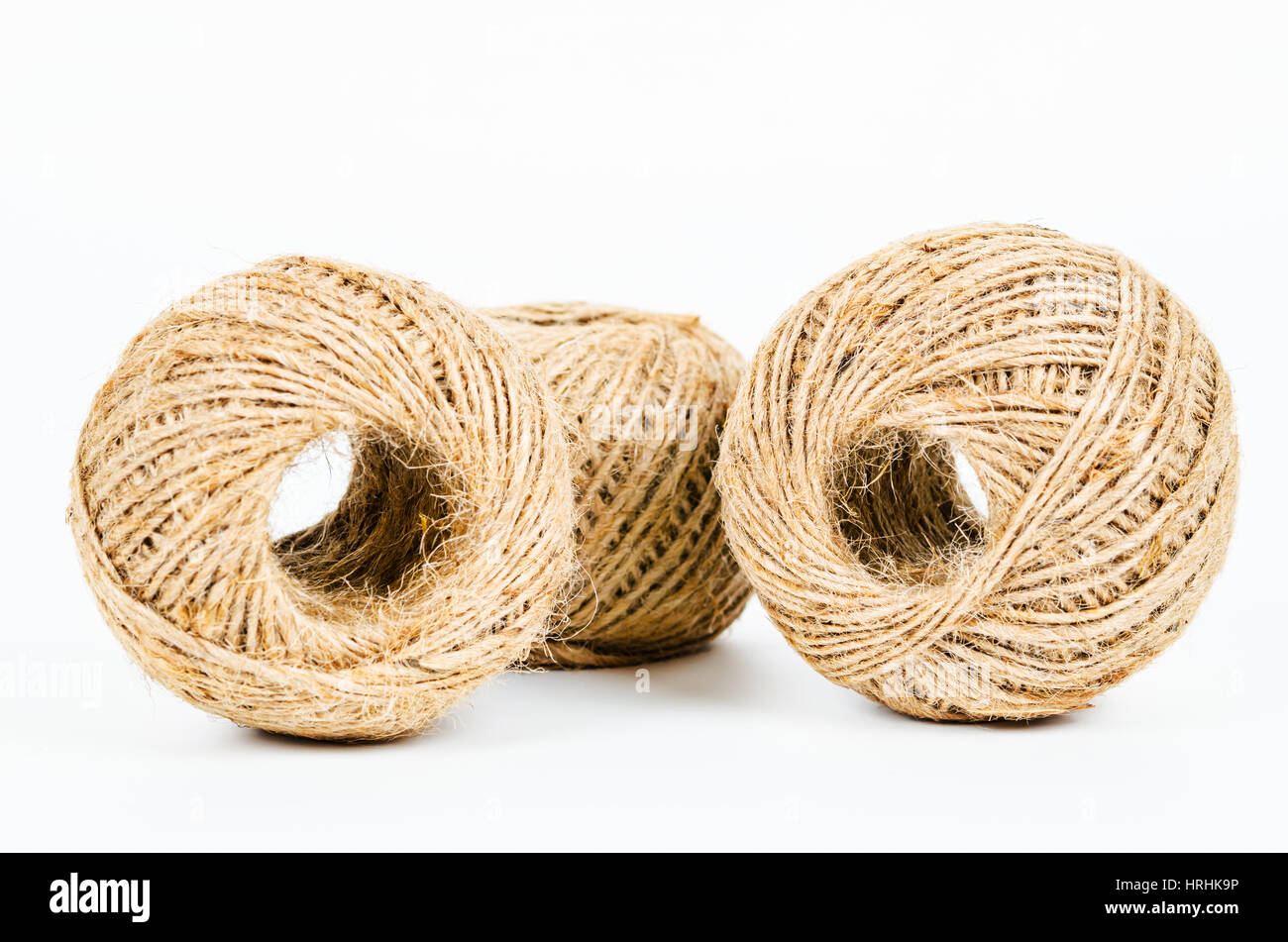 Hemp rope roll on white background Stock Photo - Alamy