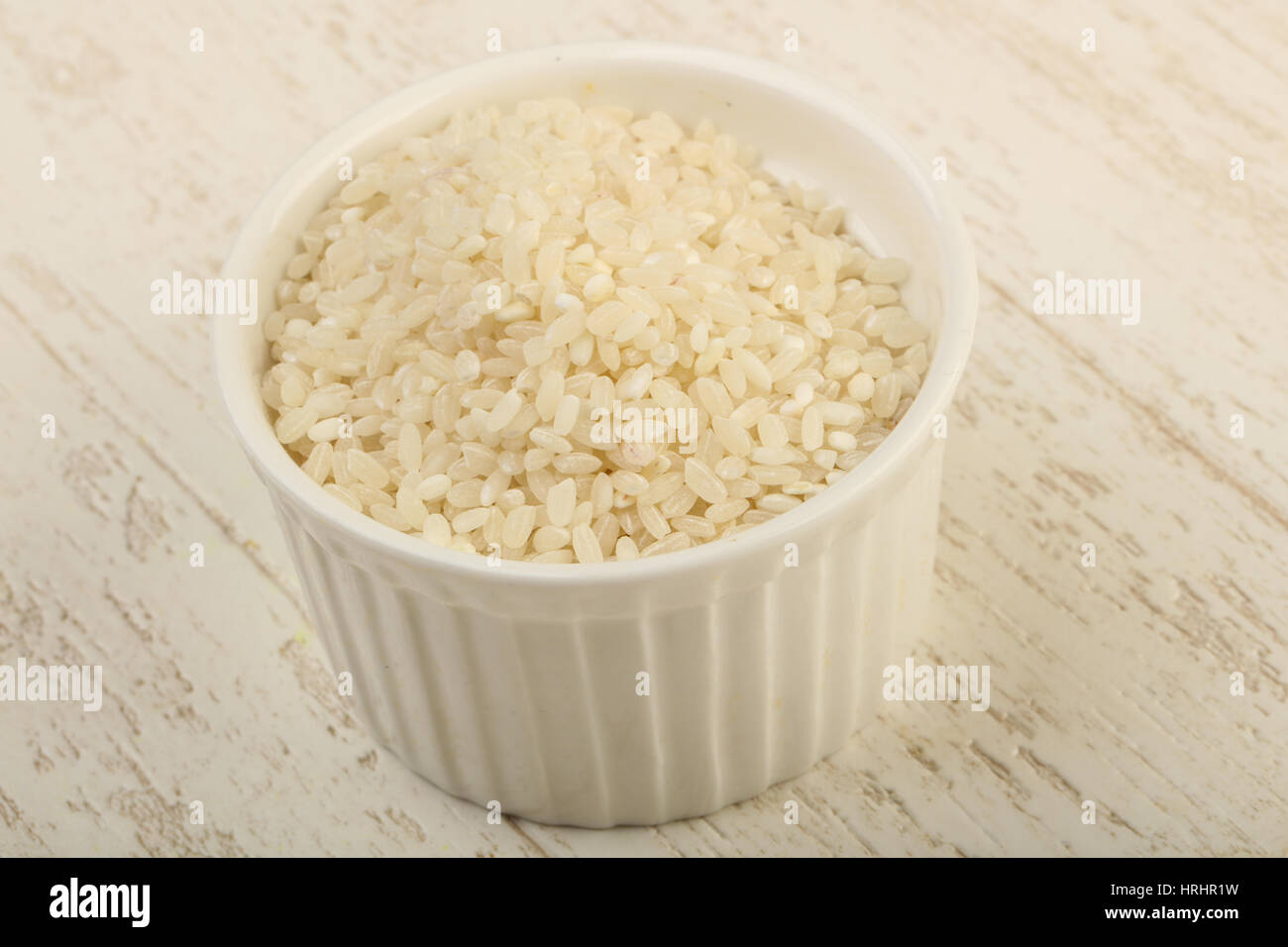 Raw rice heap in the bowl - ready for cooking Stock Photo - Alamy