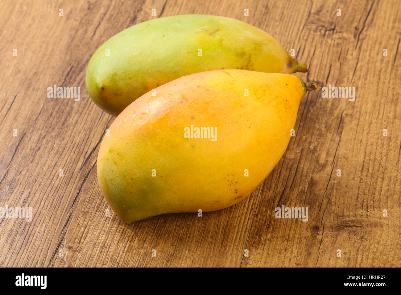 Sweet mango fruit over the wooden background Stock Photo - Alamy