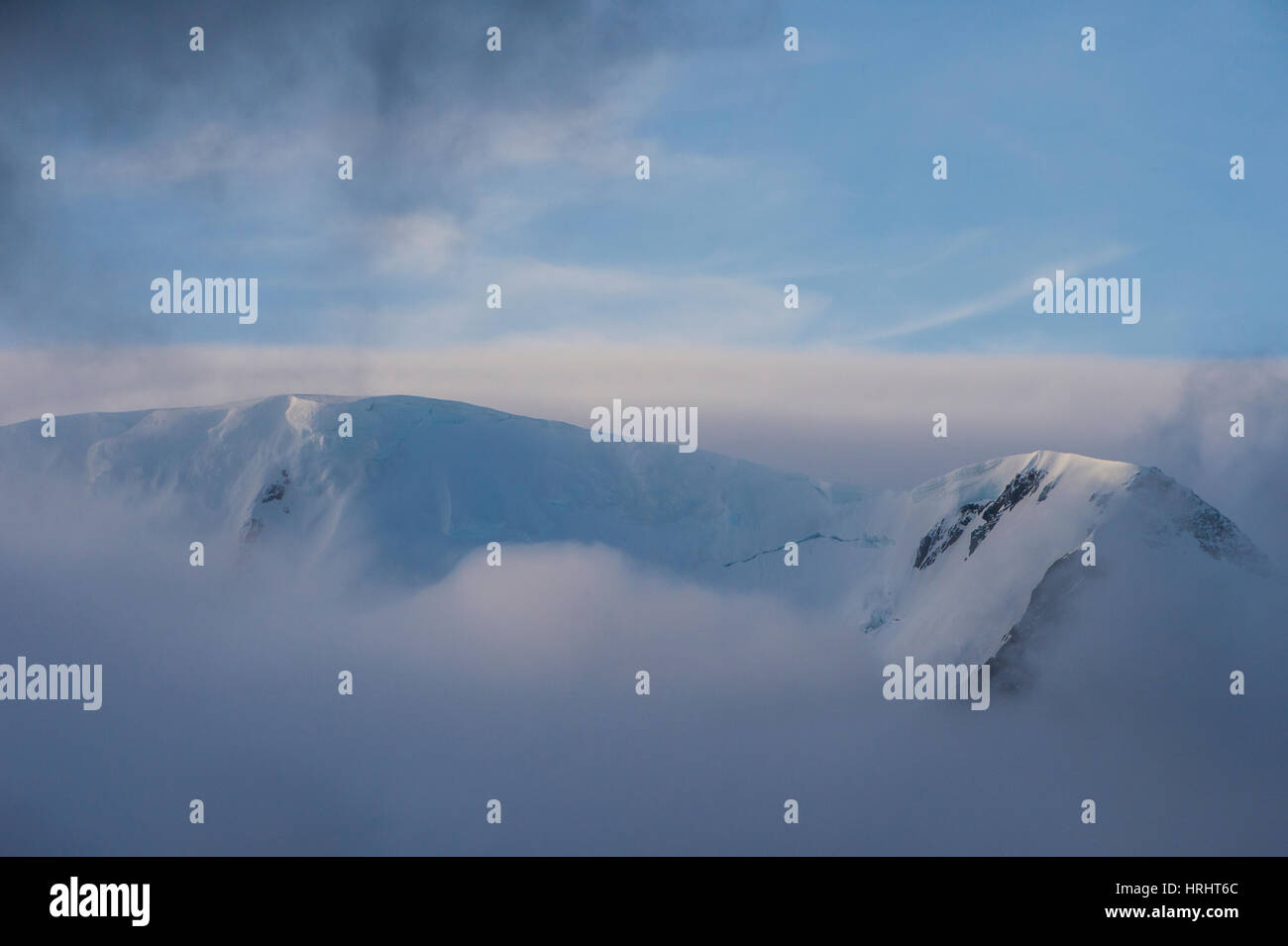 Mountain breaking through the clouds, Elephant Island, South Shetland ...