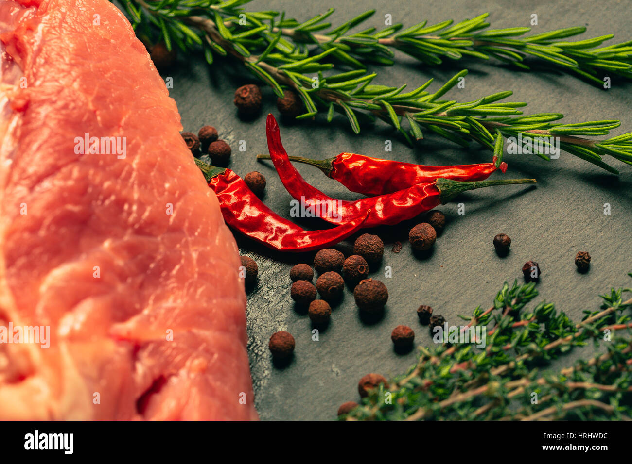 raw pork meat with spices on slate stone kitchen board Stock Photo - Alamy