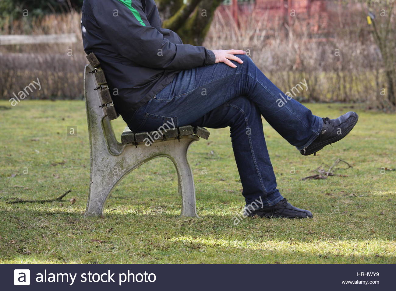 A headless figure of a man sitting on a garden seat Stock Photo - Alamy
