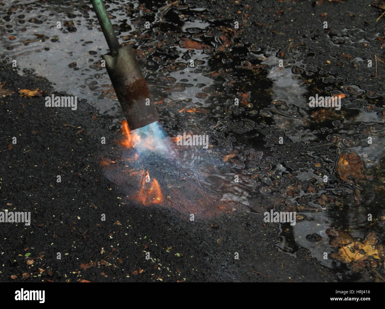 Repairing Asphalt with Propane Stock Photo - Alamy