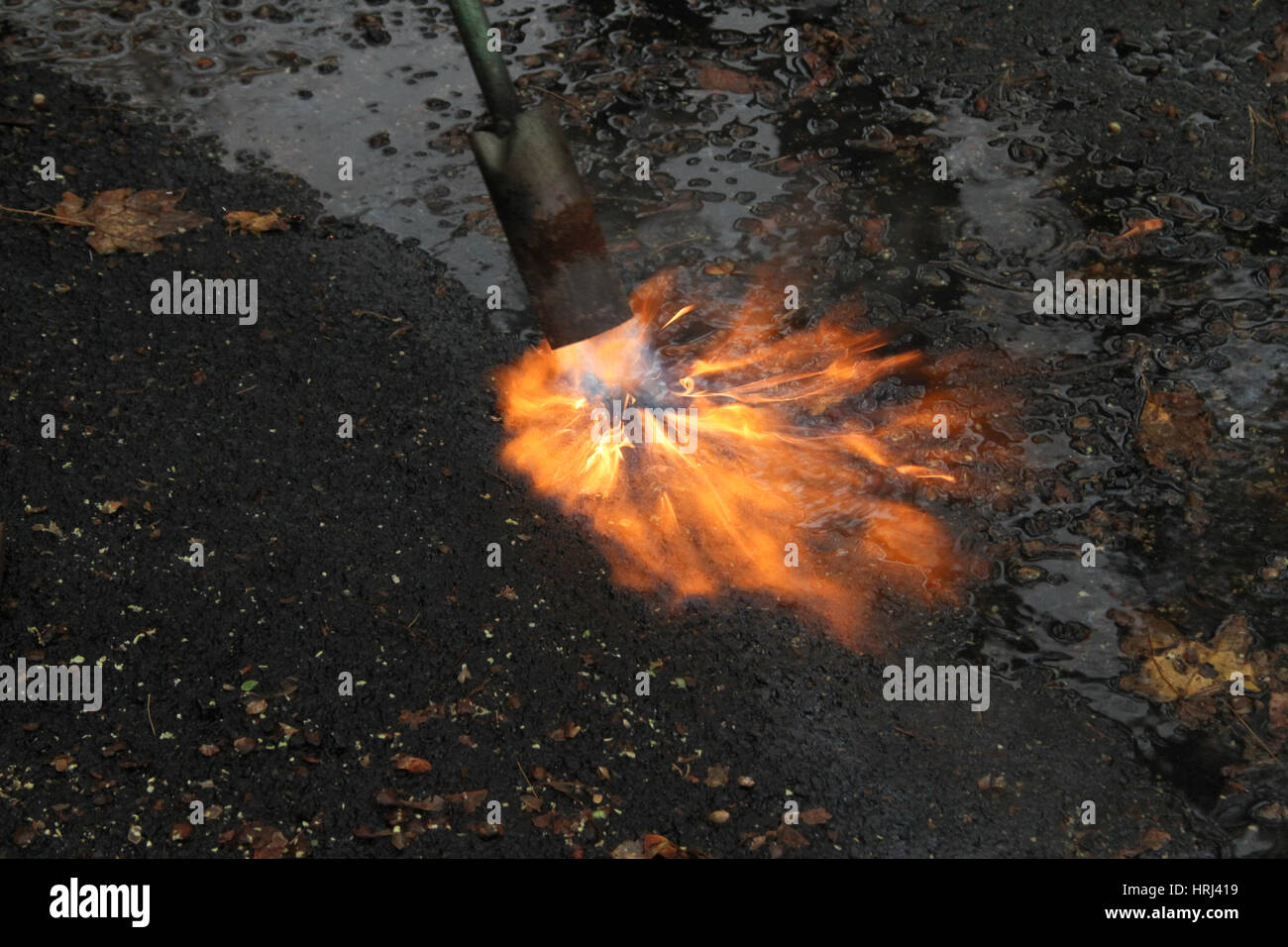 Repairing Asphalt with Propane Stock Photo - Alamy