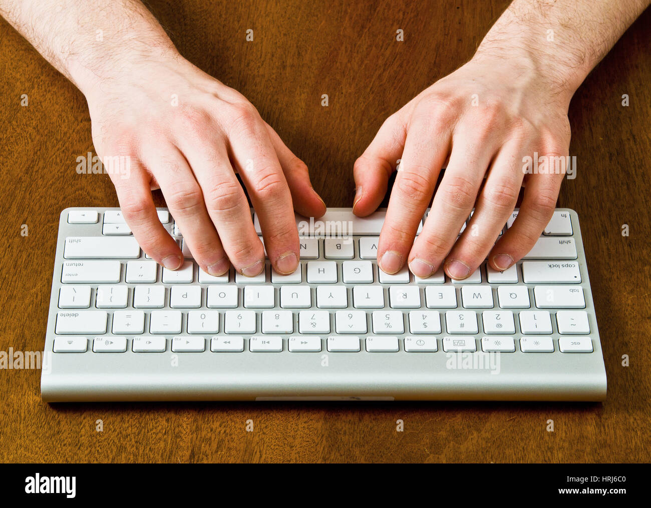 Typing on a wireless keyboard Stock Photo - Alamy