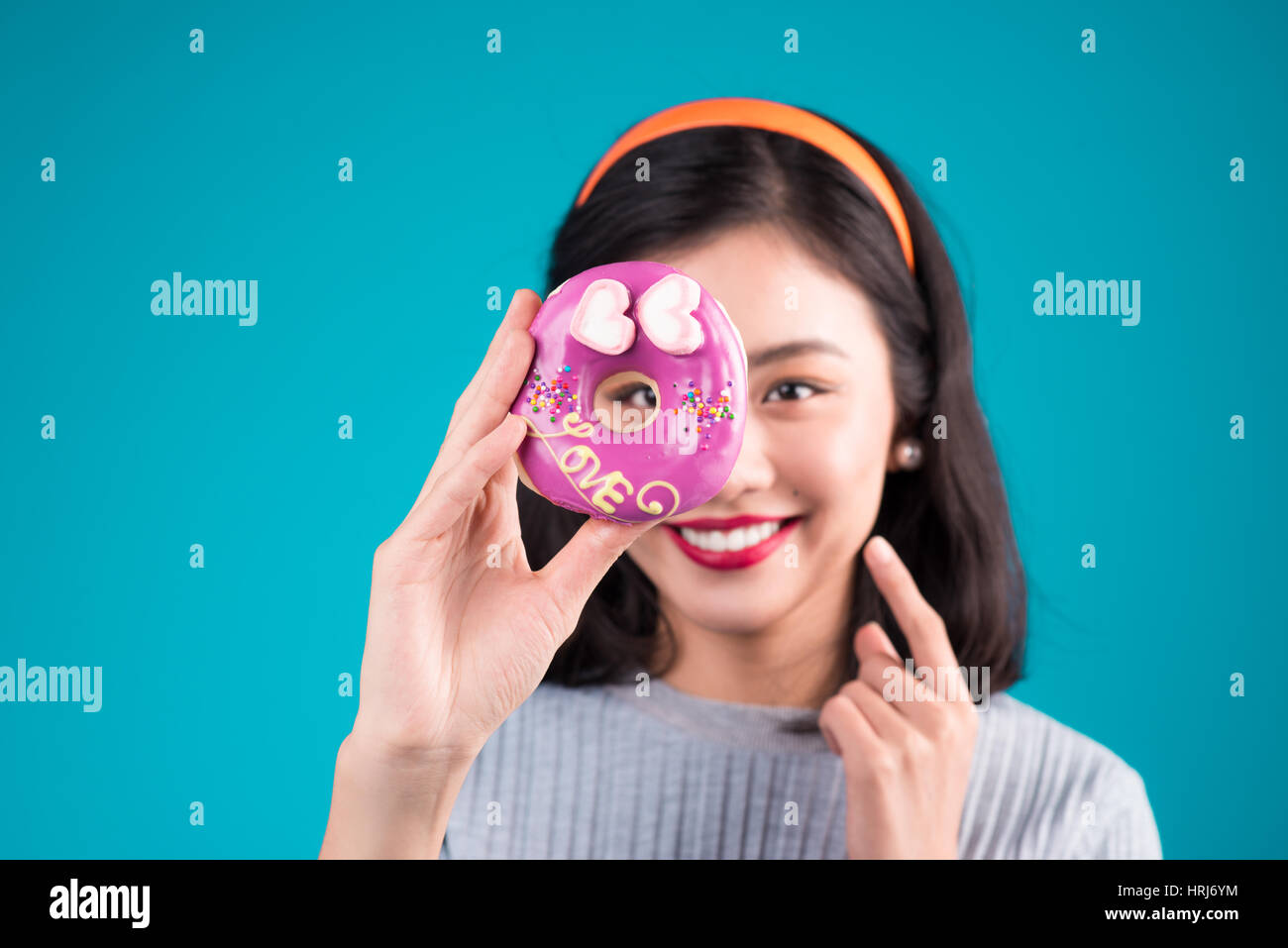 Asian beauty girl holding pink donut against her eye. Retro joyful ...