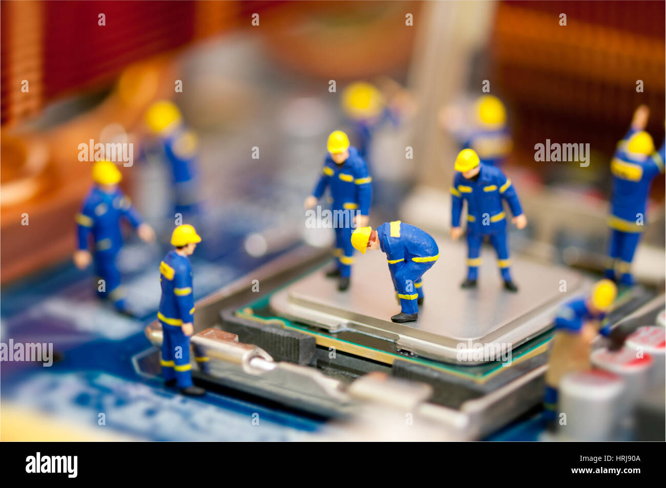 Miniature technician repairing computer Stock Photo - Alamy