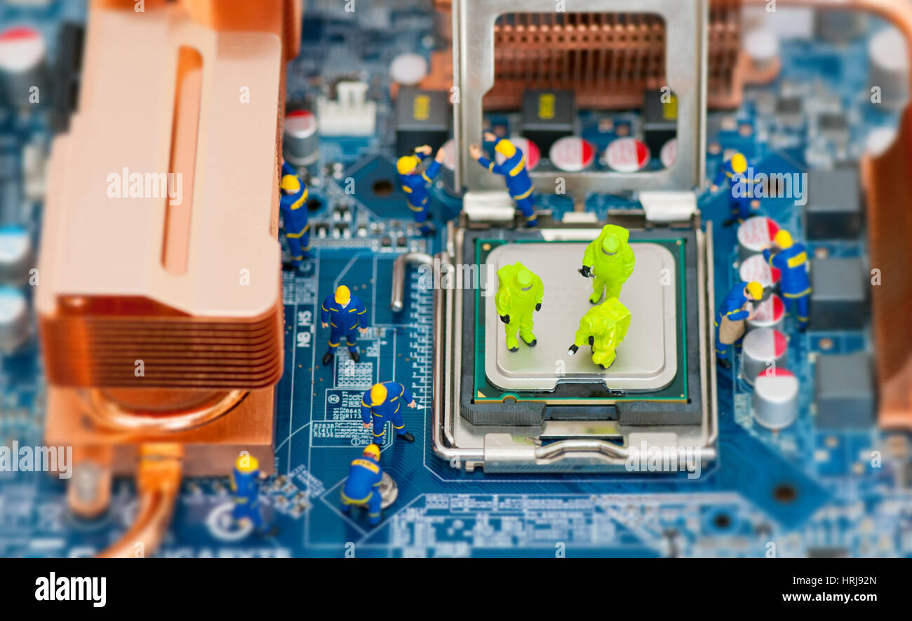 Miniature technician repairing computer Stock Photo - Alamy
