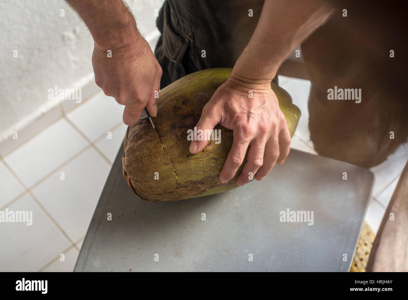 opening a coconut Stock Photo - Alamy