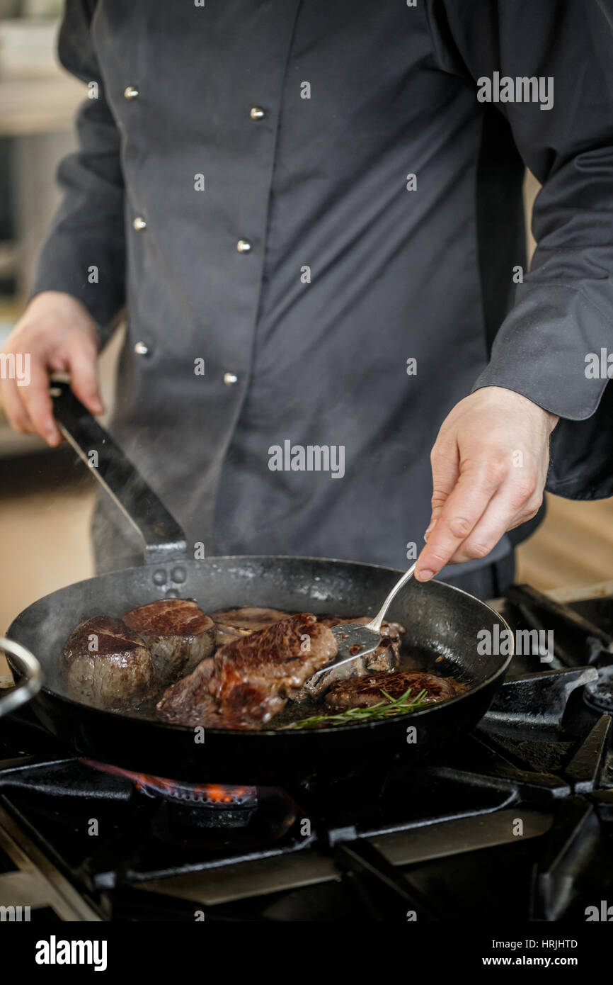 Chef in restaurant kitchen prepare meat for dinner Stock Photo - Alamy