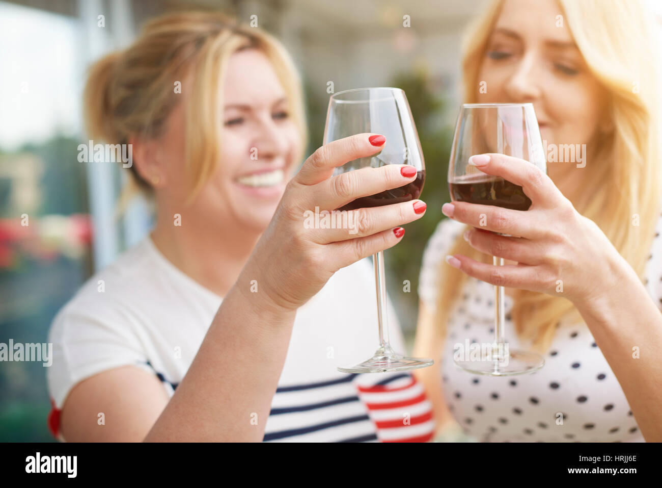 Two women cheers wine hi-res stock photography and images - Alamy