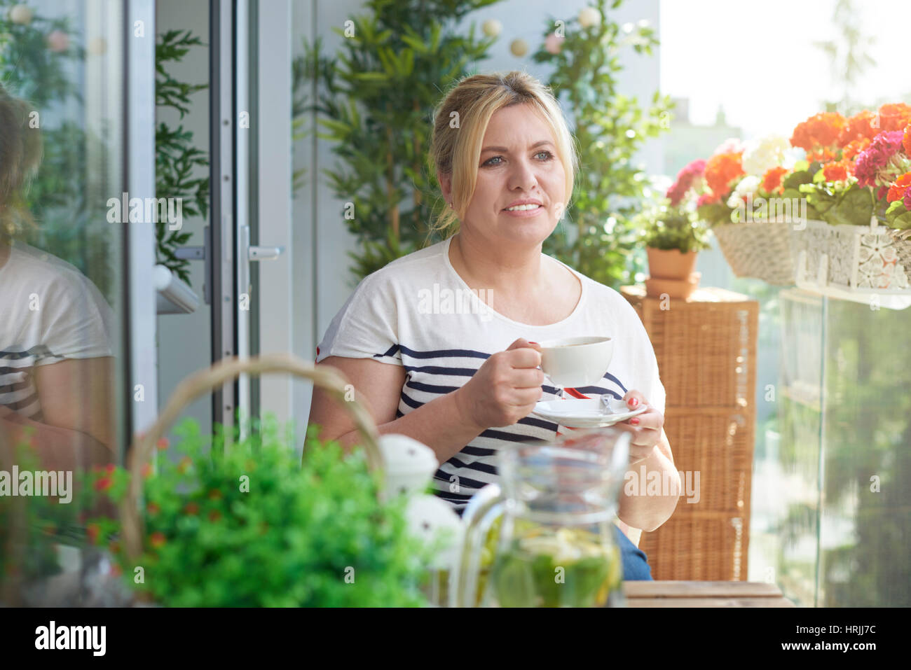 Drinking coffee on the balcony Stock Photo - Alamy