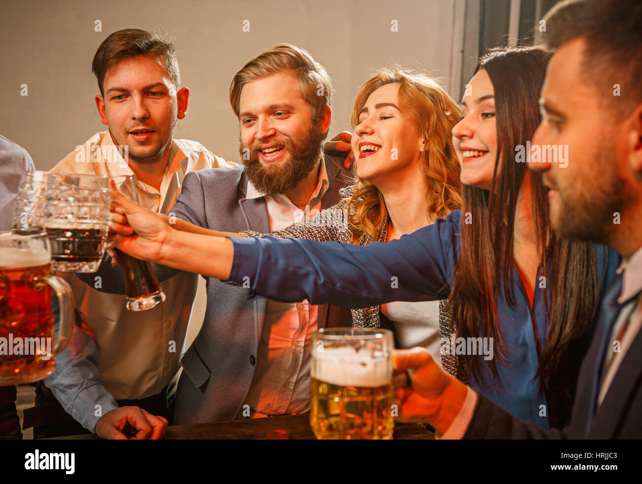 Group of friends enjoying evening drinks with beer Stock Photo - Alamy