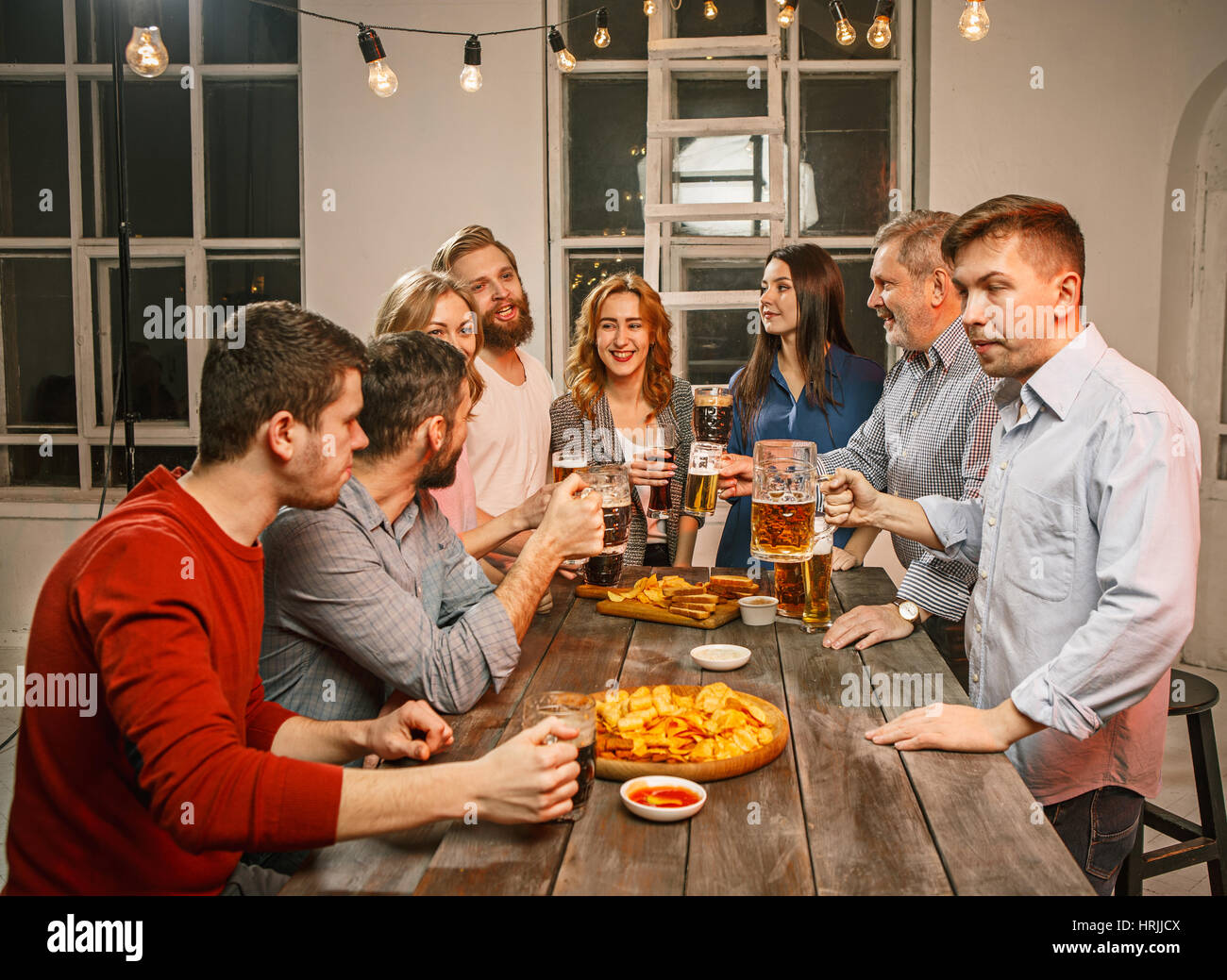 Group of friends enjoying evening drinks with beer Stock Photo - Alamy