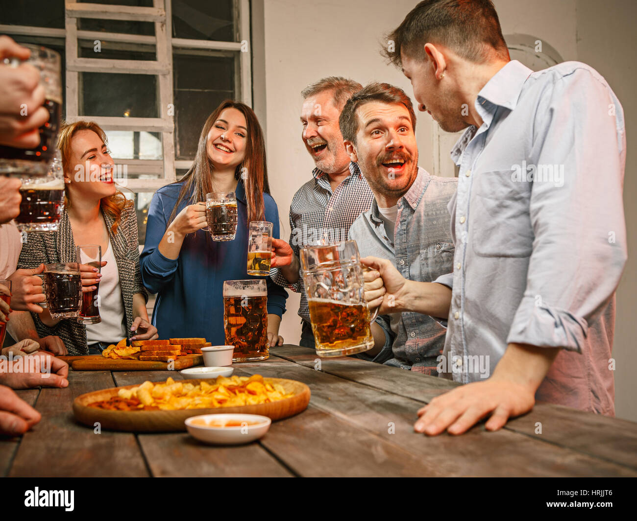 Group of friends enjoying evening drinks with beer Stock Photo - Alamy