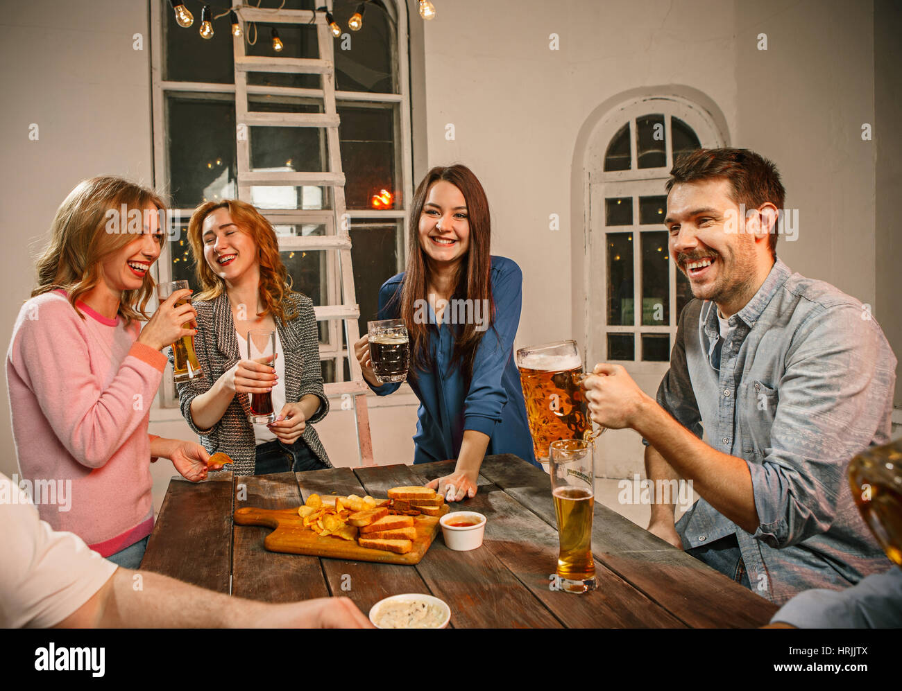 Group of friends enjoying evening drinks with beer Stock Photo - Alamy