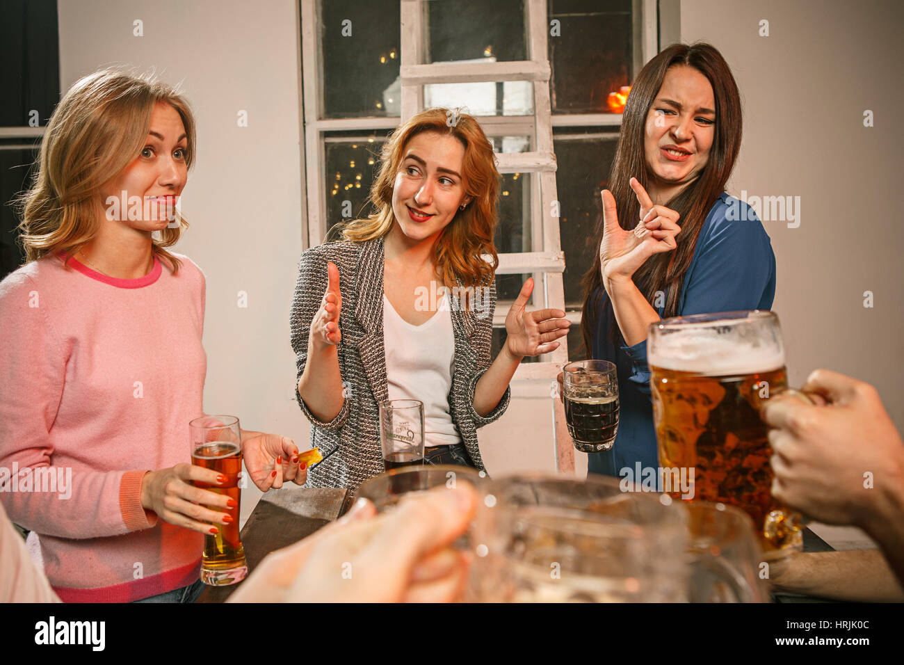 Group of friends enjoying evening drinks with beer Stock Photo - Alamy