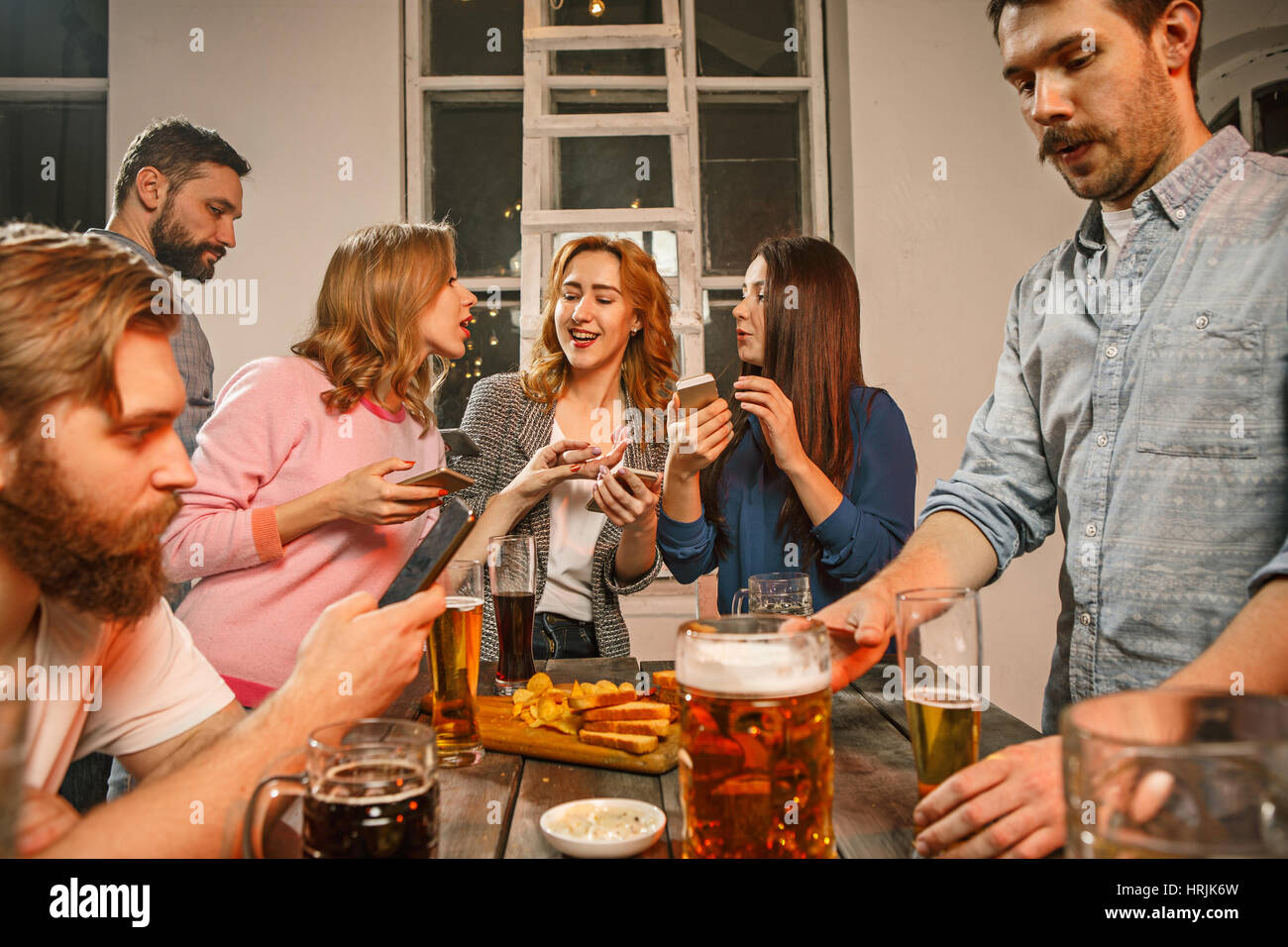 Group of friends enjoying evening drinks with beer Stock Photo - Alamy