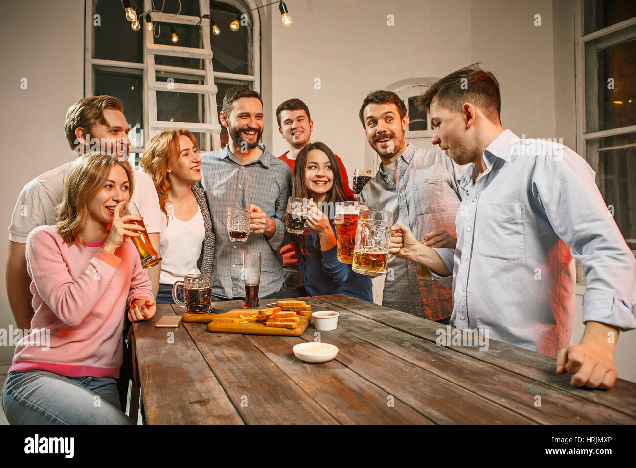 Group of friends enjoying evening drinks with beer Stock Photo - Alamy