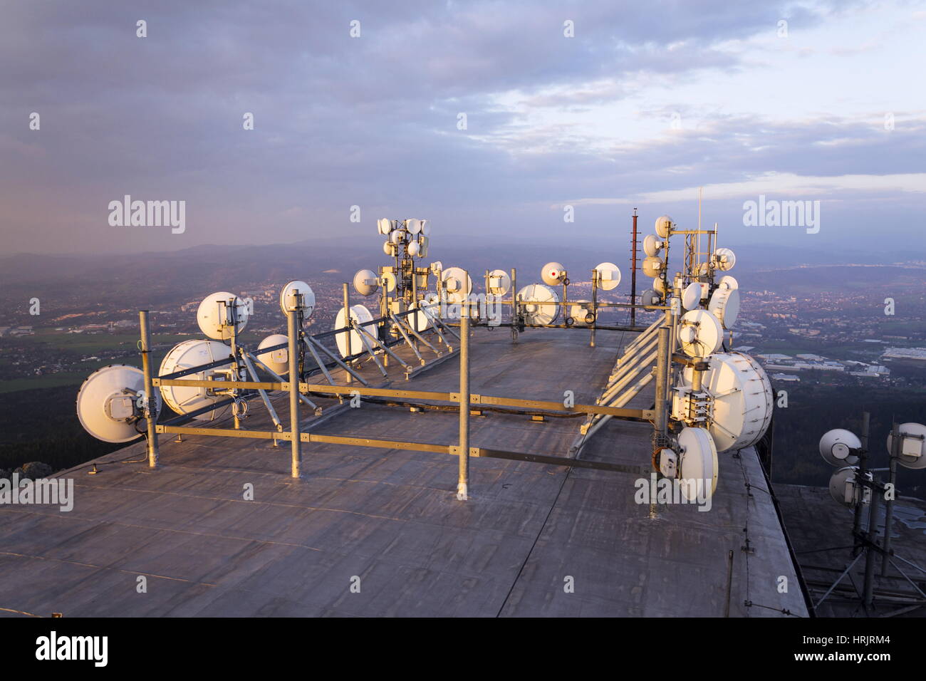 Transmitters and aerials on telecommunication tower during sunset Stock Photo - Alamy