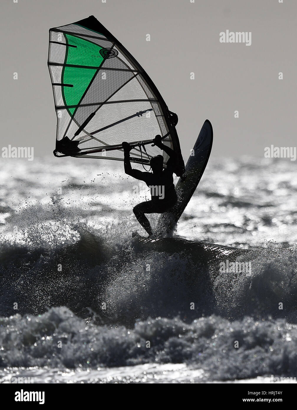 A windsurfer in the sea off East Wittering beach in West Sussex Stock ...