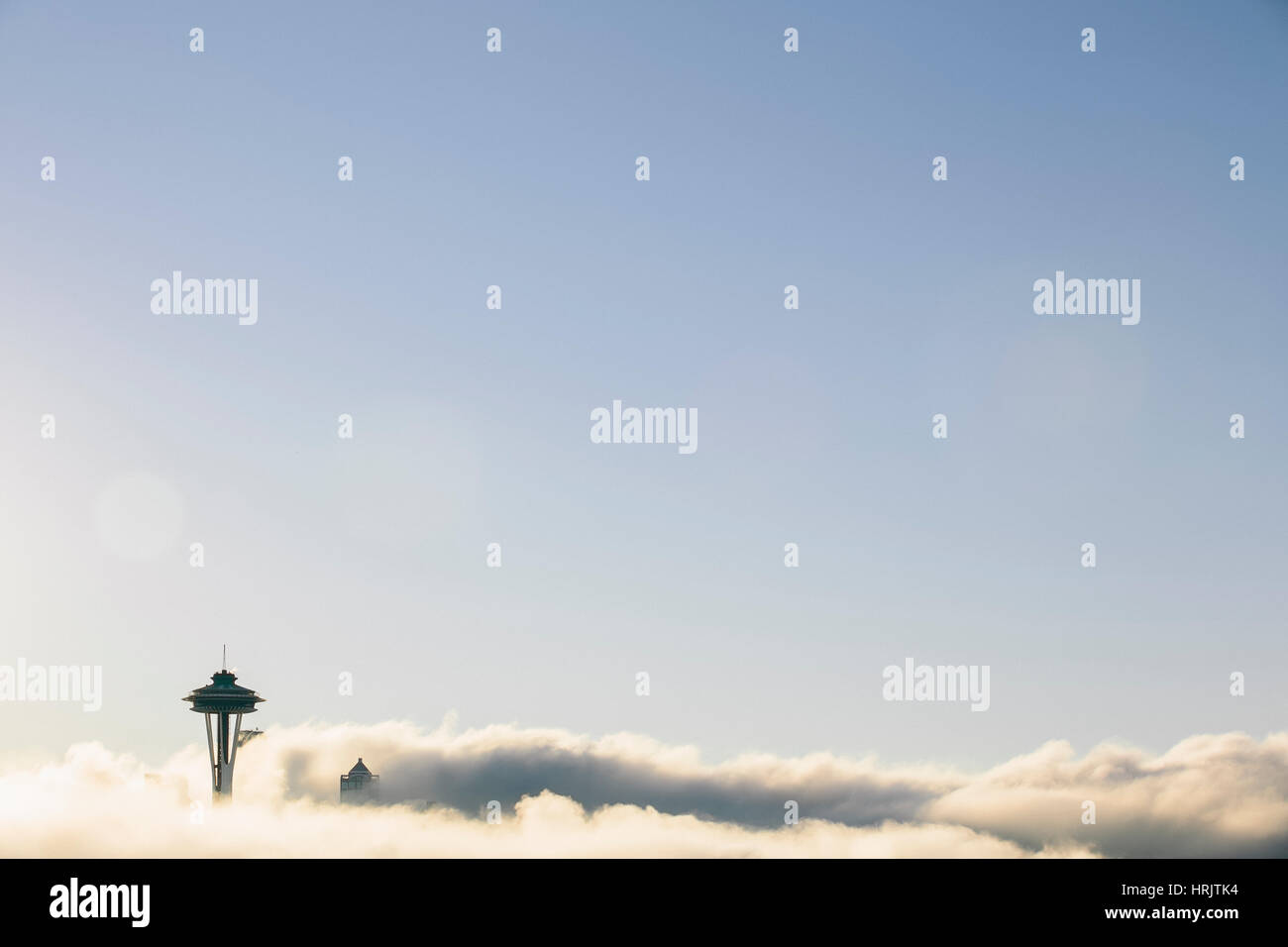 The top of the Space Needle tower seen rising above a thick layer of ...