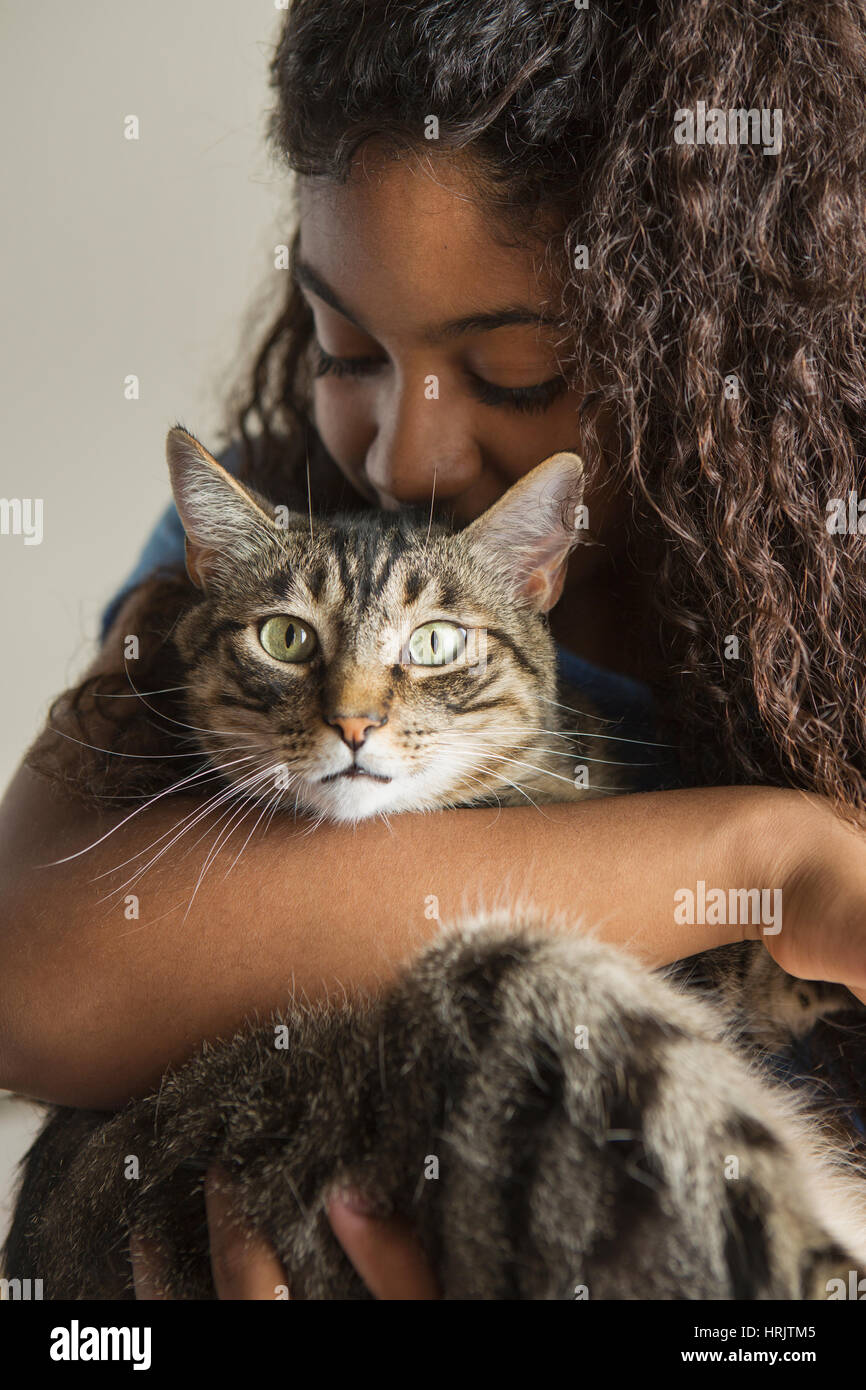 A girl cuddling a pet cat Stock Photo - Alamy