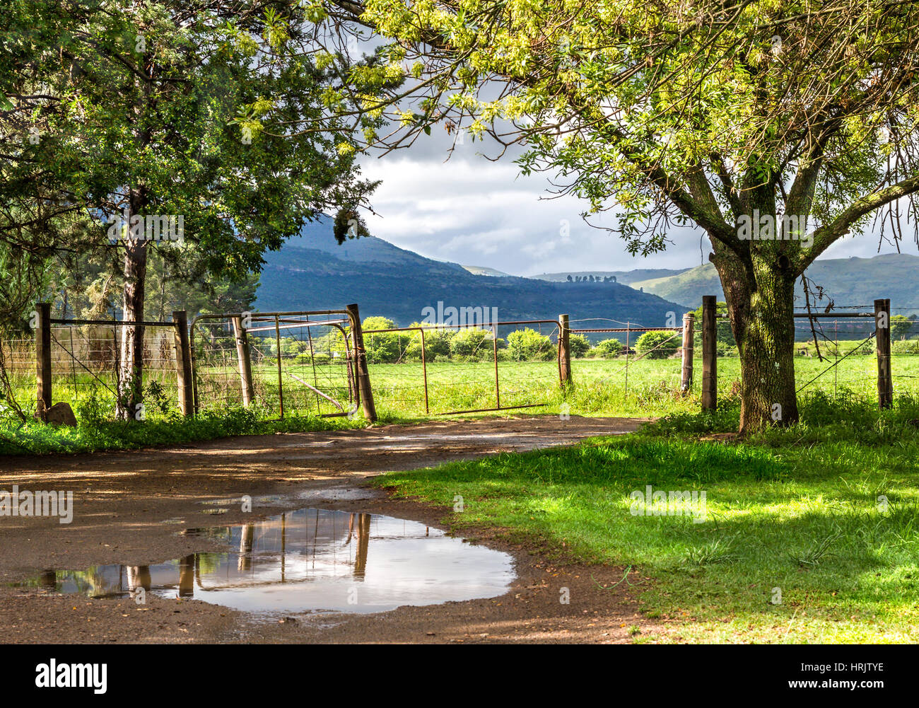 Rural landscape with sun breaking though after the rain with hills and ...