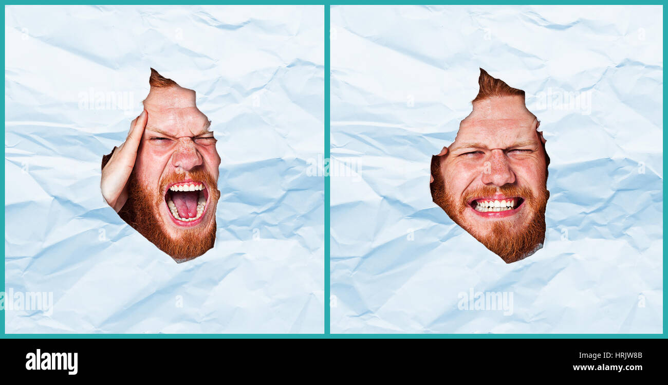 Young man looking through paper rip Stock Photo - Alamy