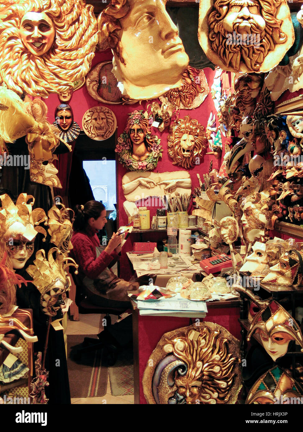 Artisan crafts exquisite Venetian masks in vibrant workshop filled with ...