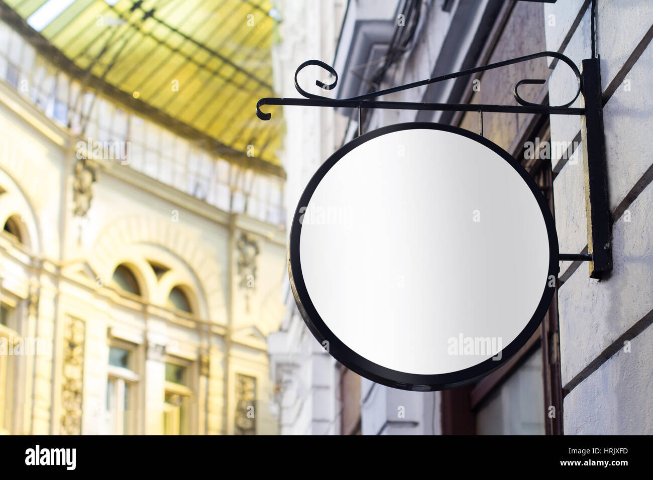 Horizontal front view of empty round signage on a building with ...