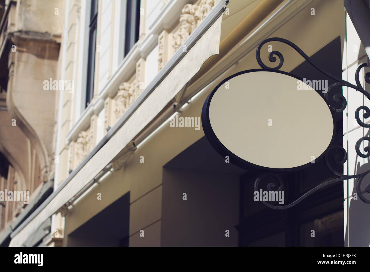 Horizontal front view of empty round signage on a building with ...