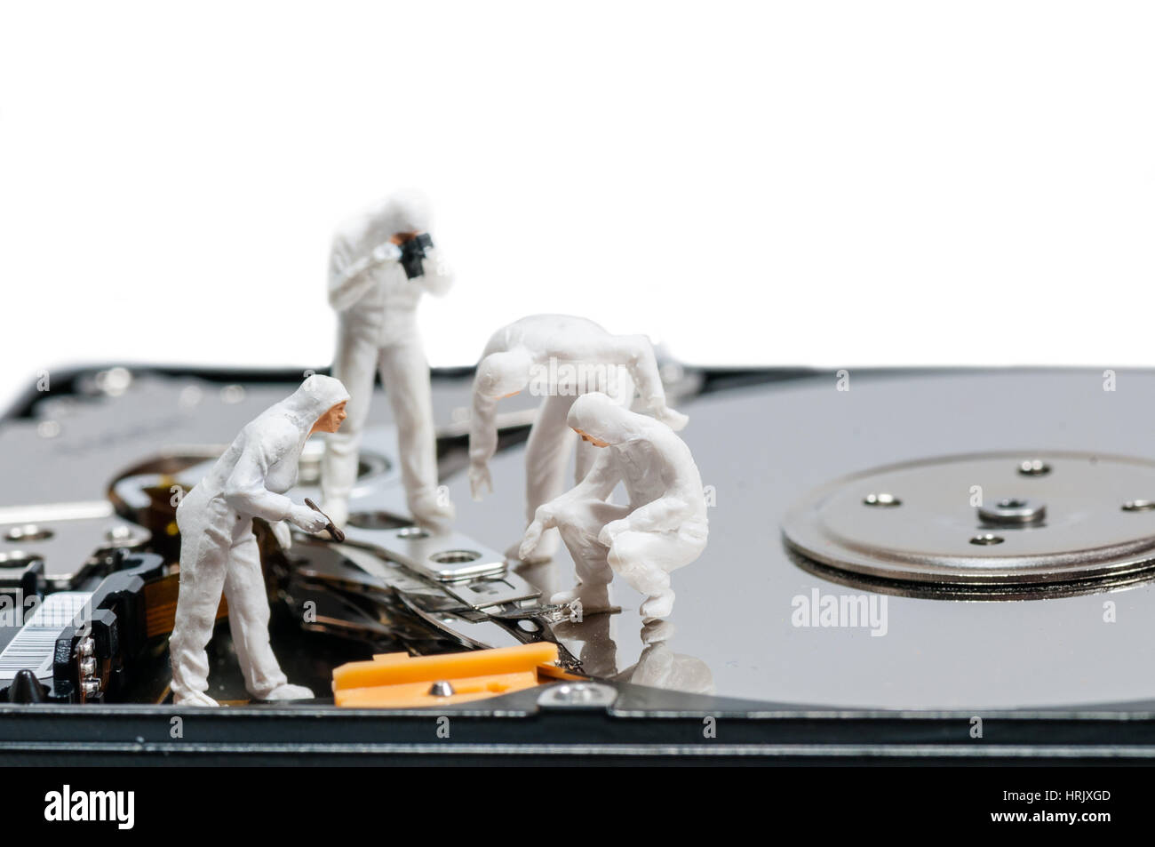 Group of criminologists inspecting broken hard rive. Technology concept ...