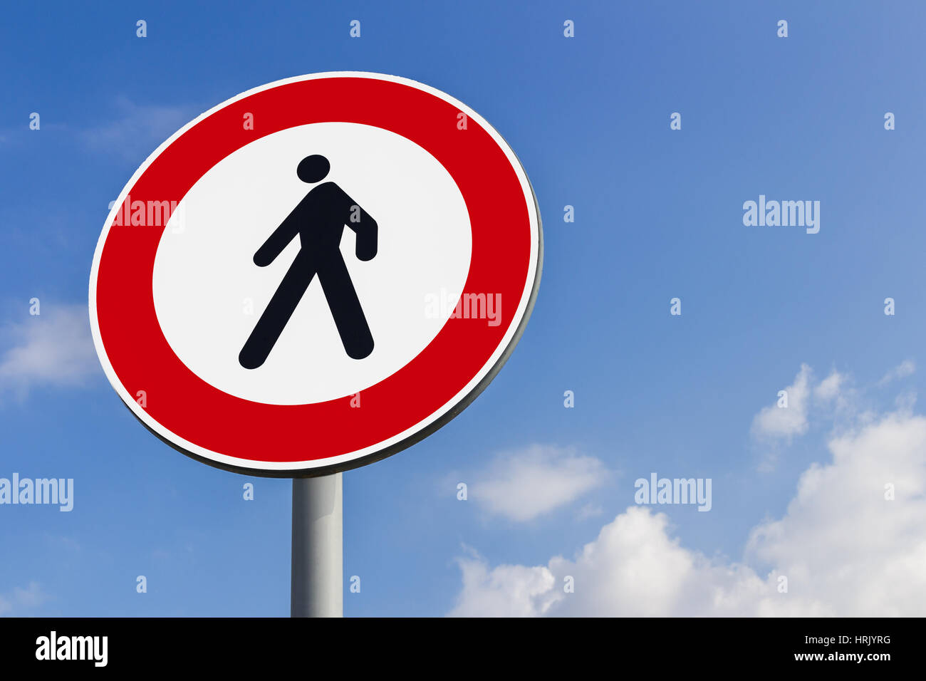 Walking forbidden sign on a blue sky with clouds Stock Photo - Alamy