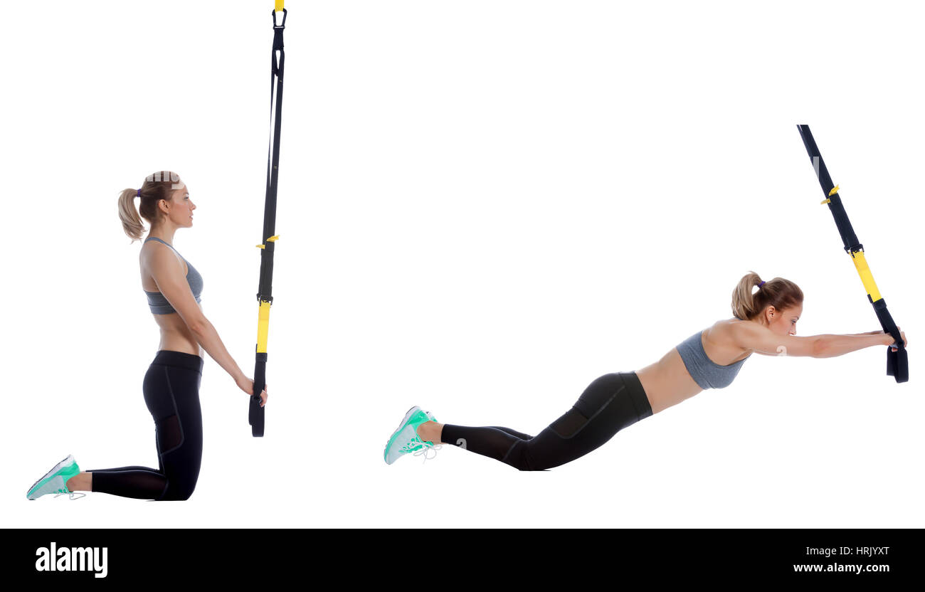 Athletic woman performing a functional exercise with suspension cable ...