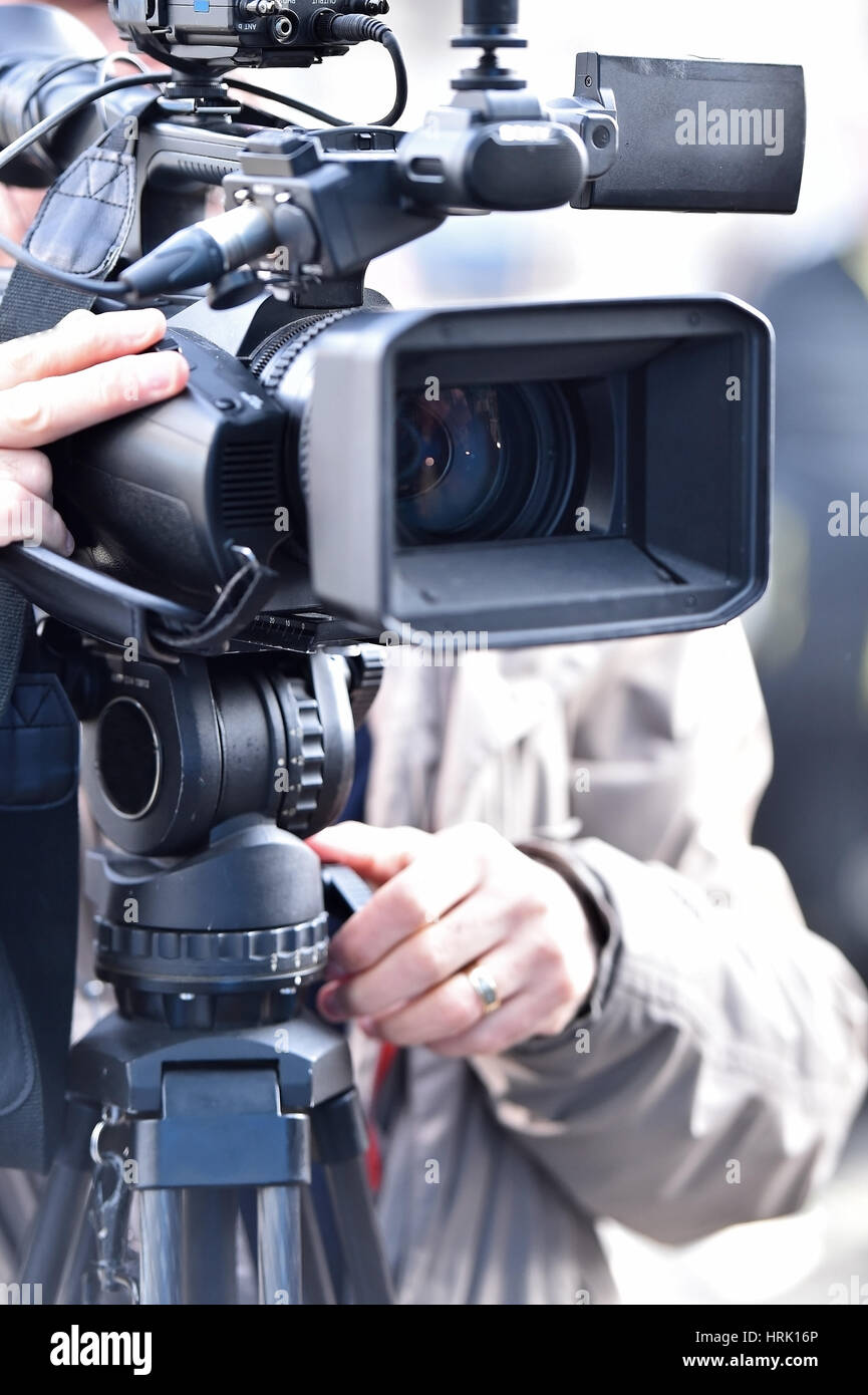 Lots of television cameras in a row broadcasting a live media event ...