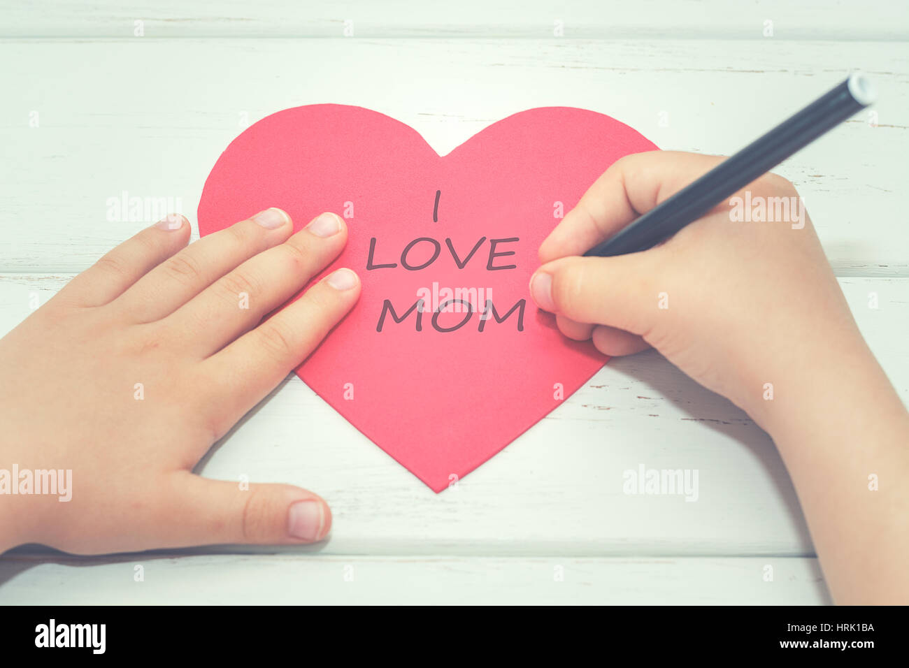 I love mom.Children's hands write a heart Stock Photo - Alamy