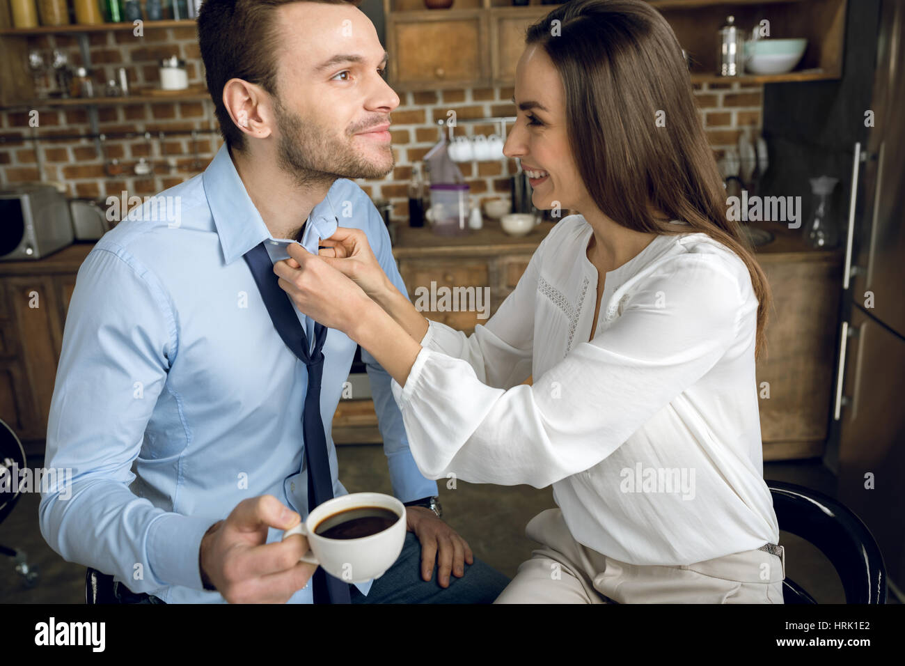 Handsome husband helping happy hi-res stock photography and images - Alamy