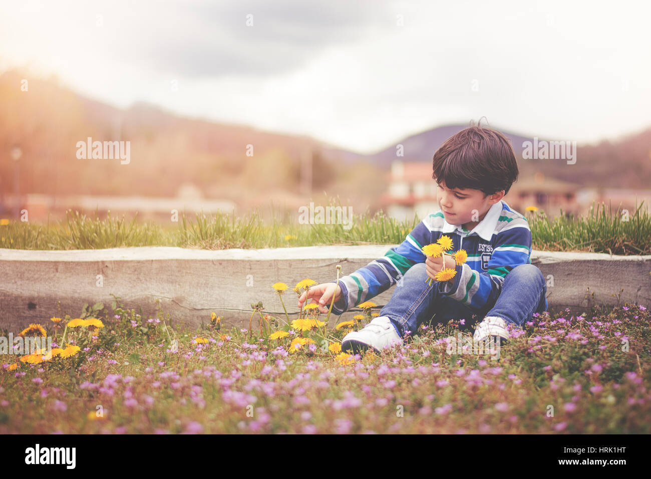 child with spring flowers. Child outdoor portrait Stock Photo - Alamy
