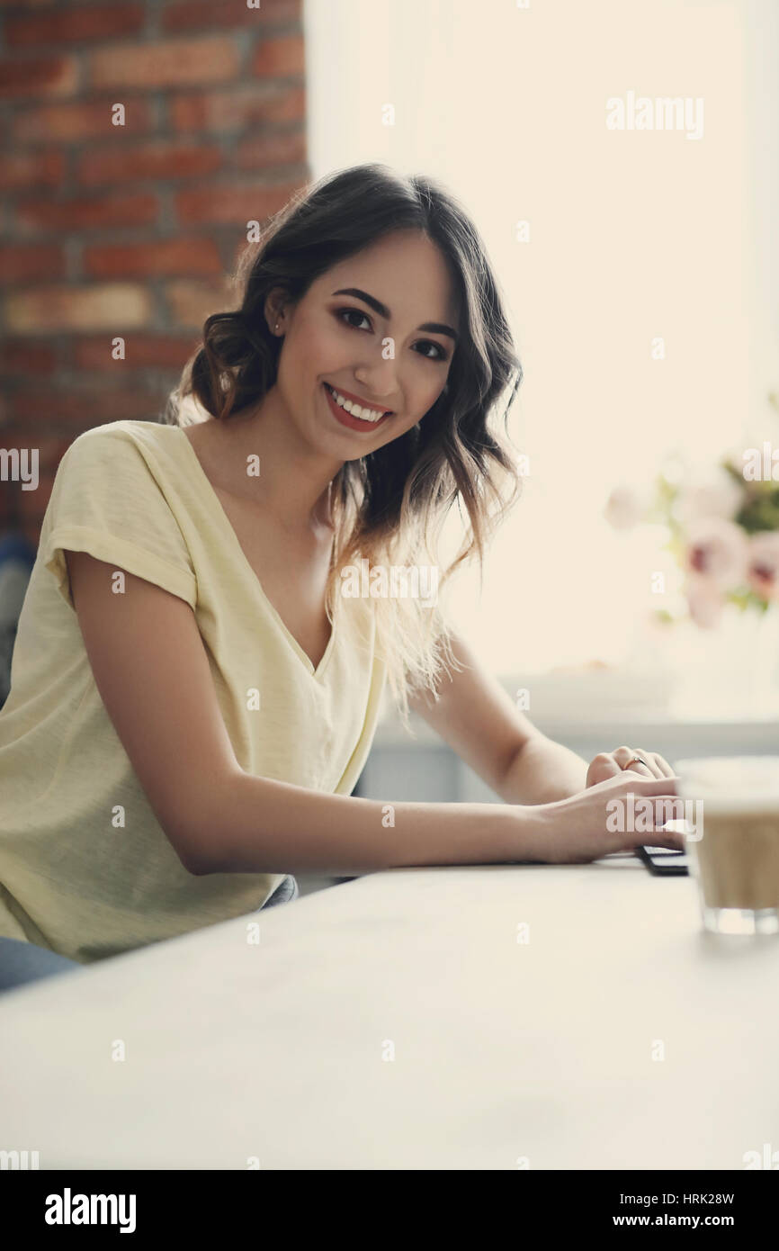 Lovely girl by the table Stock Photo - Alamy