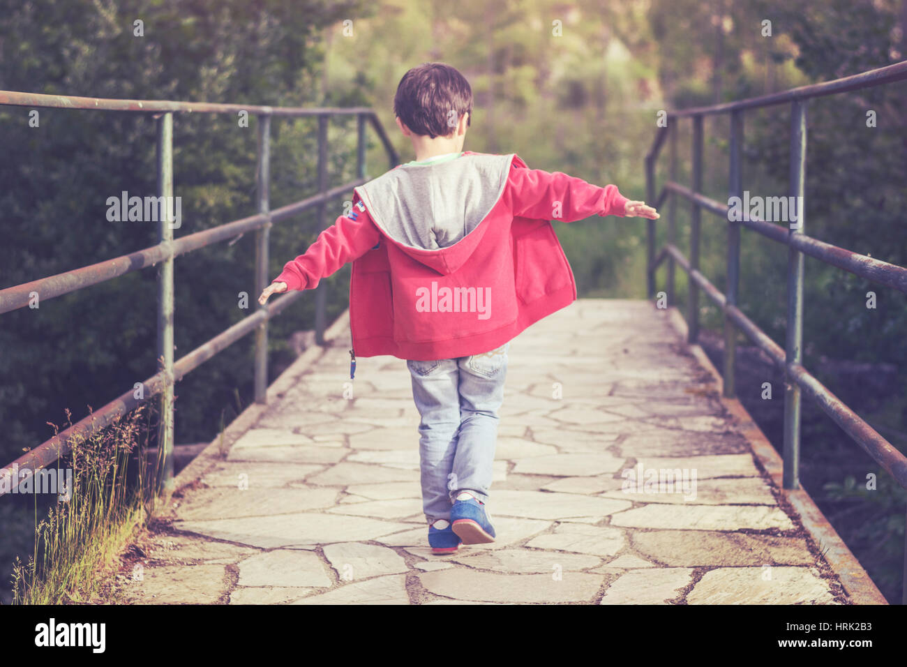 child playing outdoors, Back view Stock Photo - Alamy