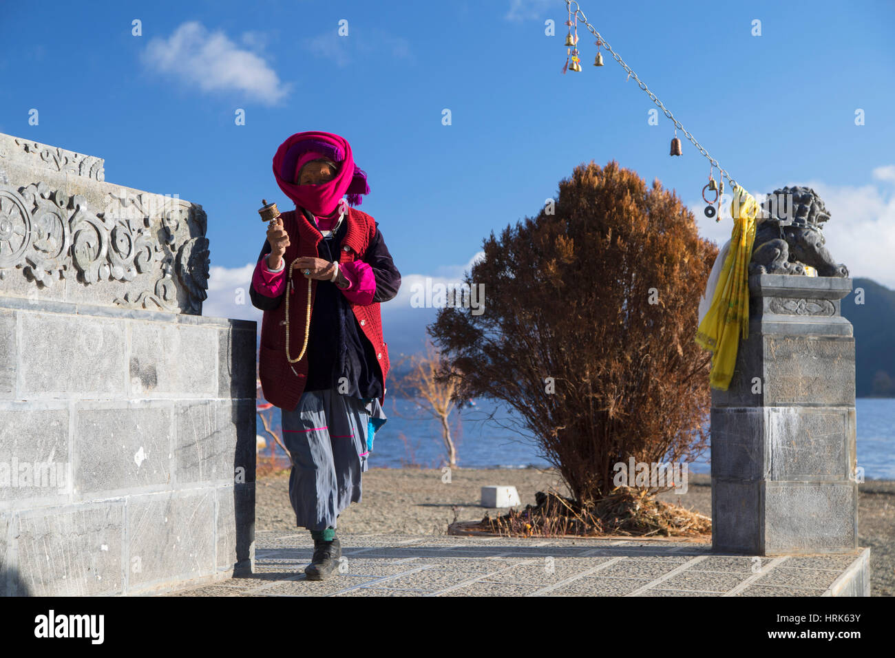 Mosu woman praying at shrine, Luoshui, Lugu Lake, Yunnan, China Stock ...