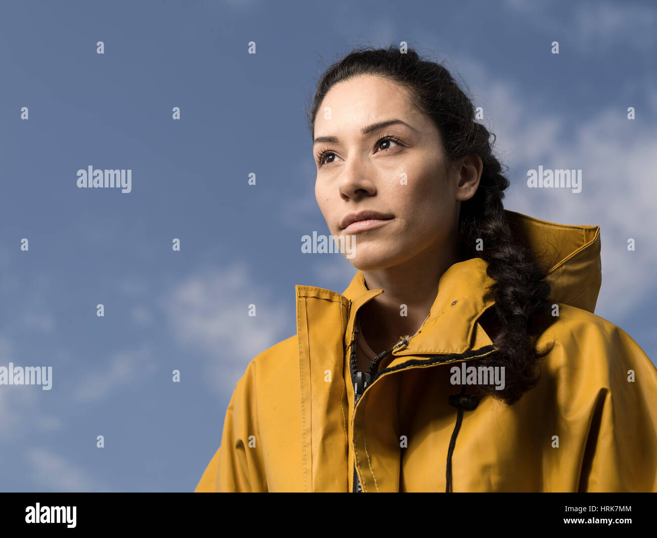 Woman wearing yellow storm jacket Stock Photo - Alamy