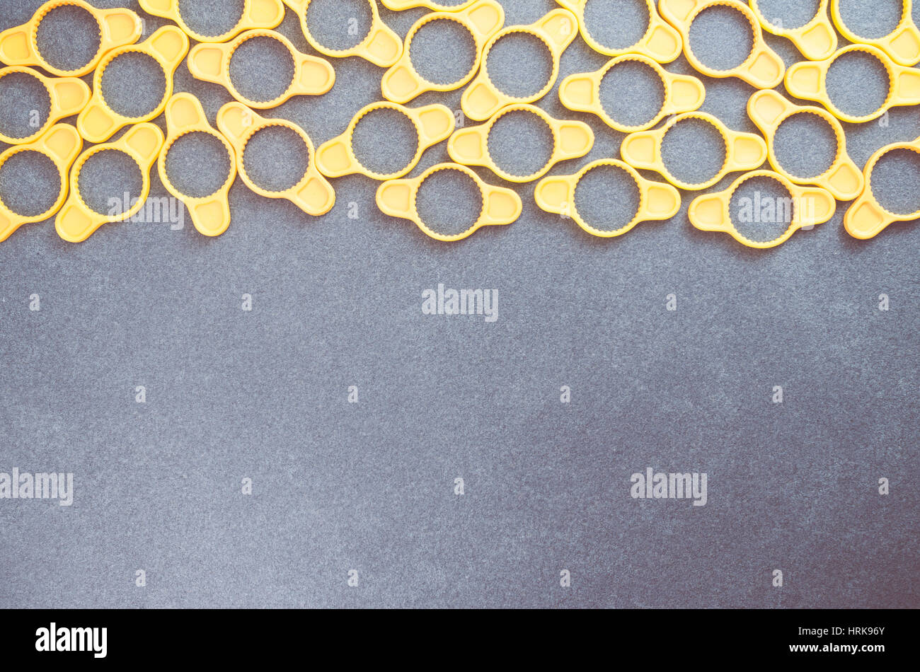 yellow plastic objects on a dark surface - abstracts backgrounds Stock ...