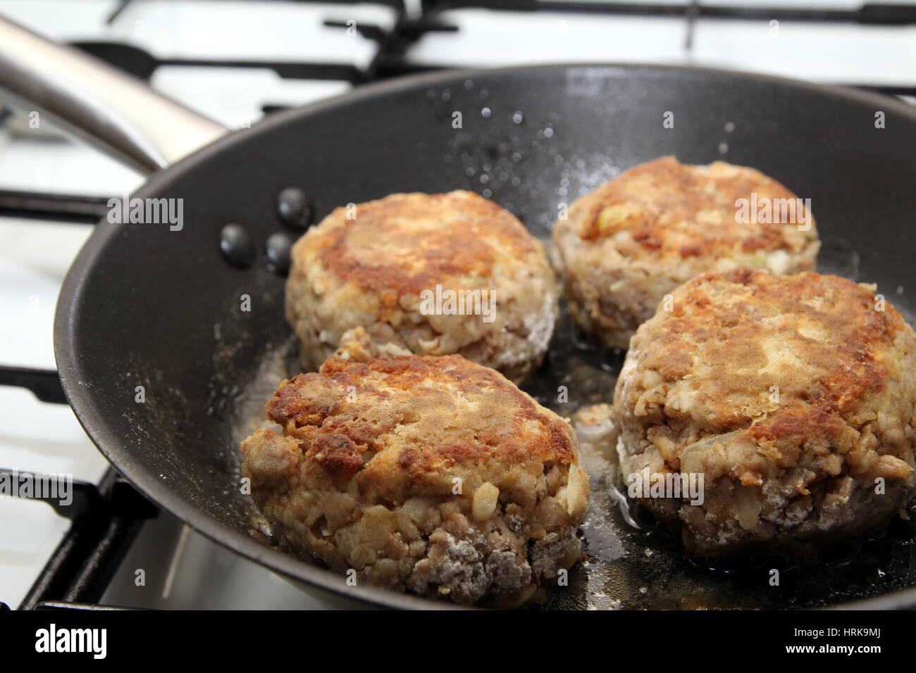 Rissoles, made from minced meat, onion and breadcrumbs, frying in a pan ...