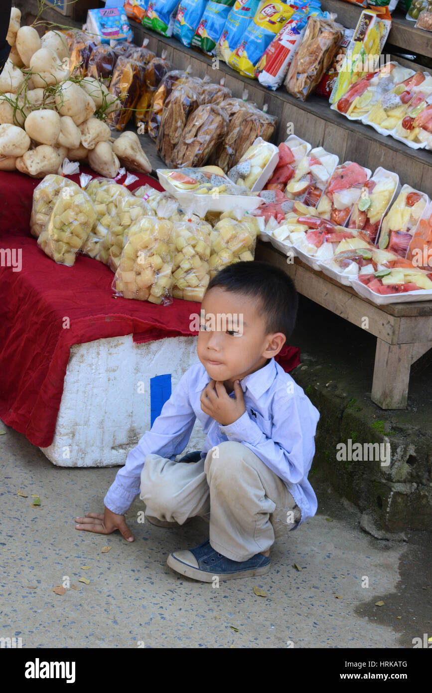 Little boy by market stall, Cambodia Stock Photo - Alamy
